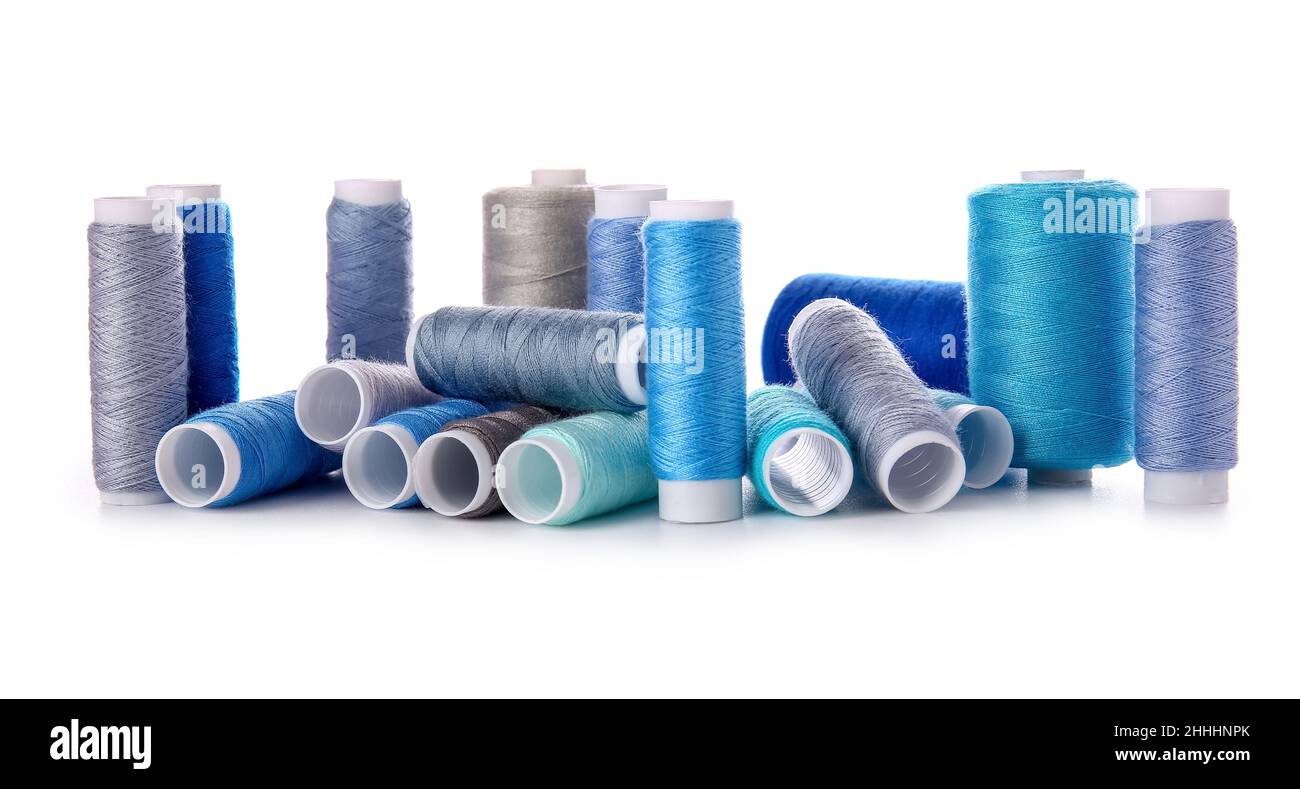 Different sewing thread spools on white background Stock Photo - Alamy