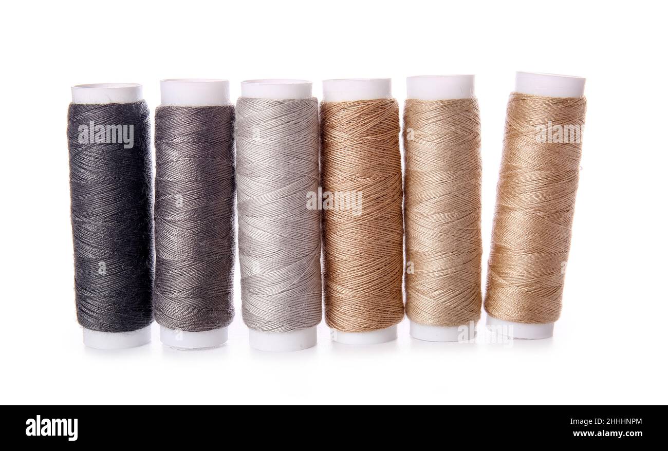 Different sewing thread spools on white background Stock Photo - Alamy