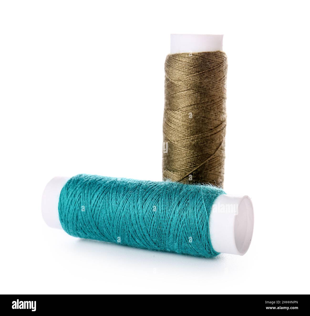 Different sewing thread spools on white background Stock Photo - Alamy