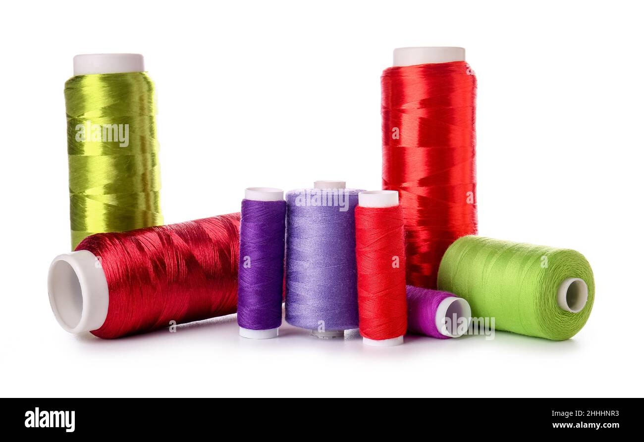 Different sewing thread spools on white background Stock Photo - Alamy