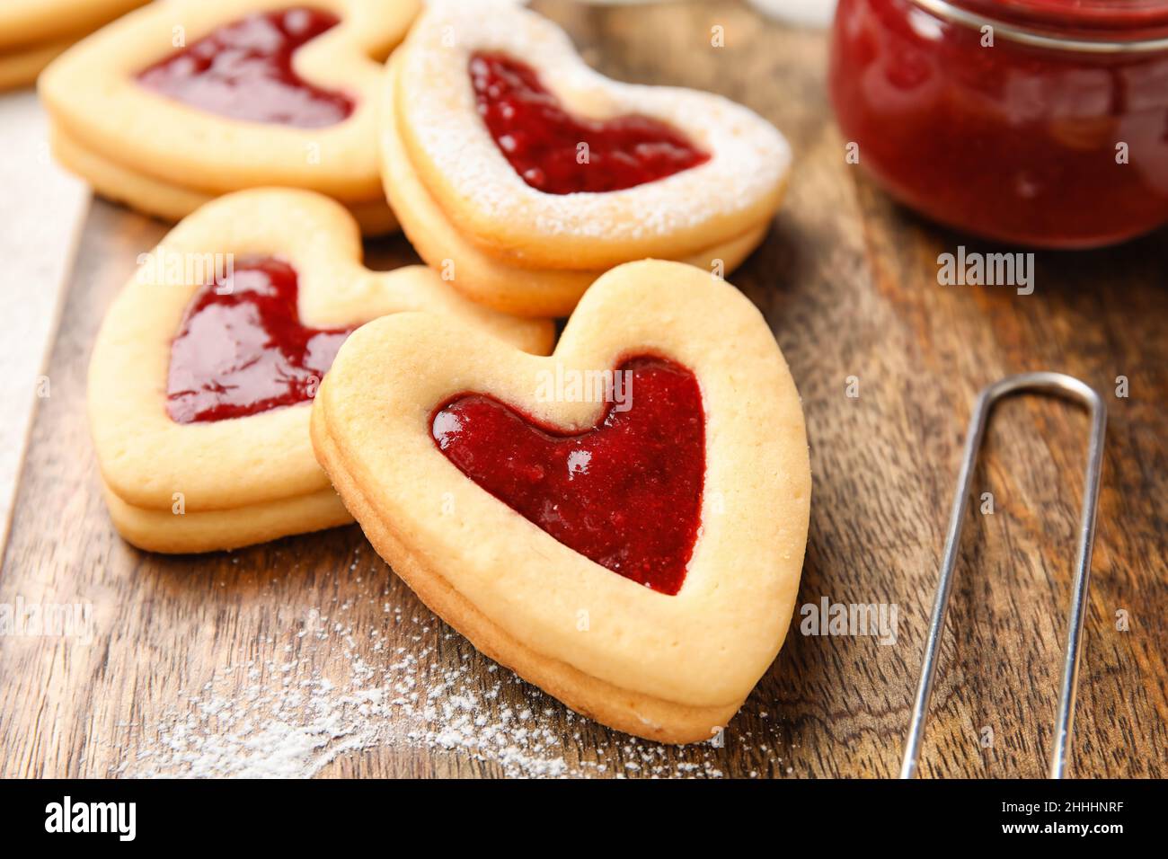 Board with tasty cookies for Valentine's Day celebration on table ...