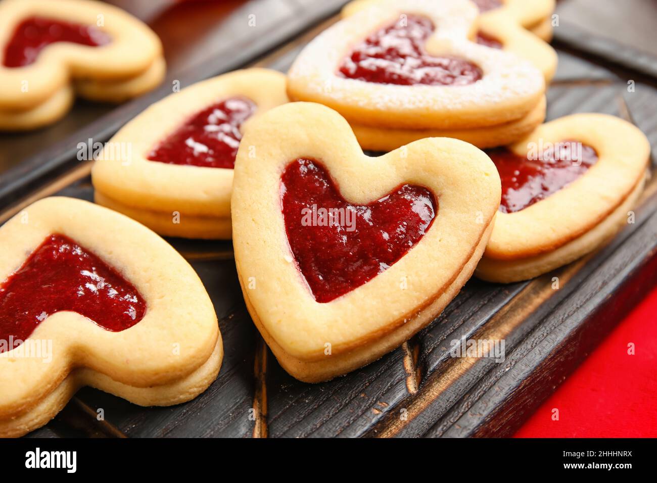 Board with tasty cookies for Valentine's Day celebration on table ...