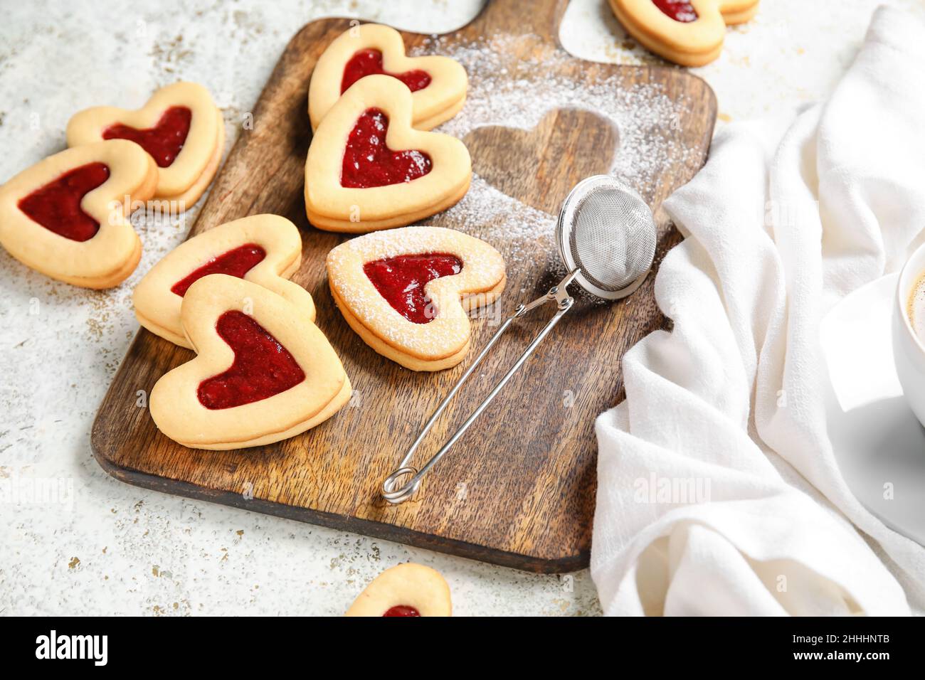 Board with tasty cookies for Valentine's Day celebration on light ...