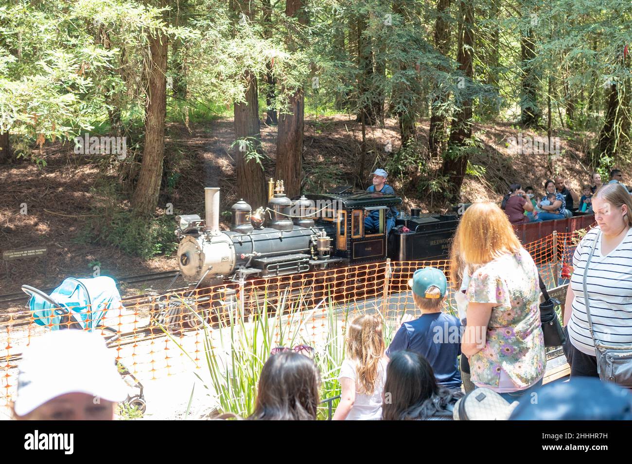 People wait in line as a locomotive approaches the station at the ...