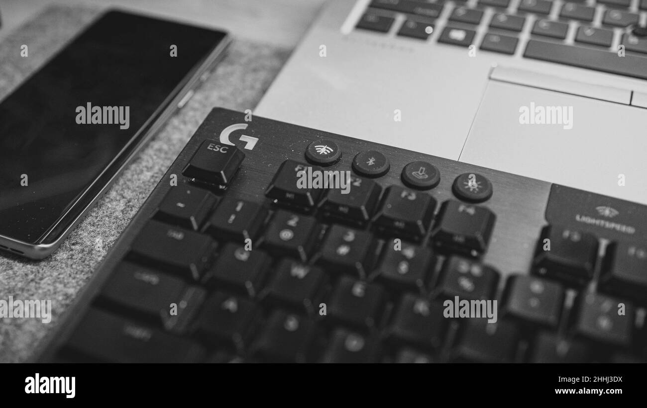 Office desk with partially visble keyboard and modern mobile phone ...
