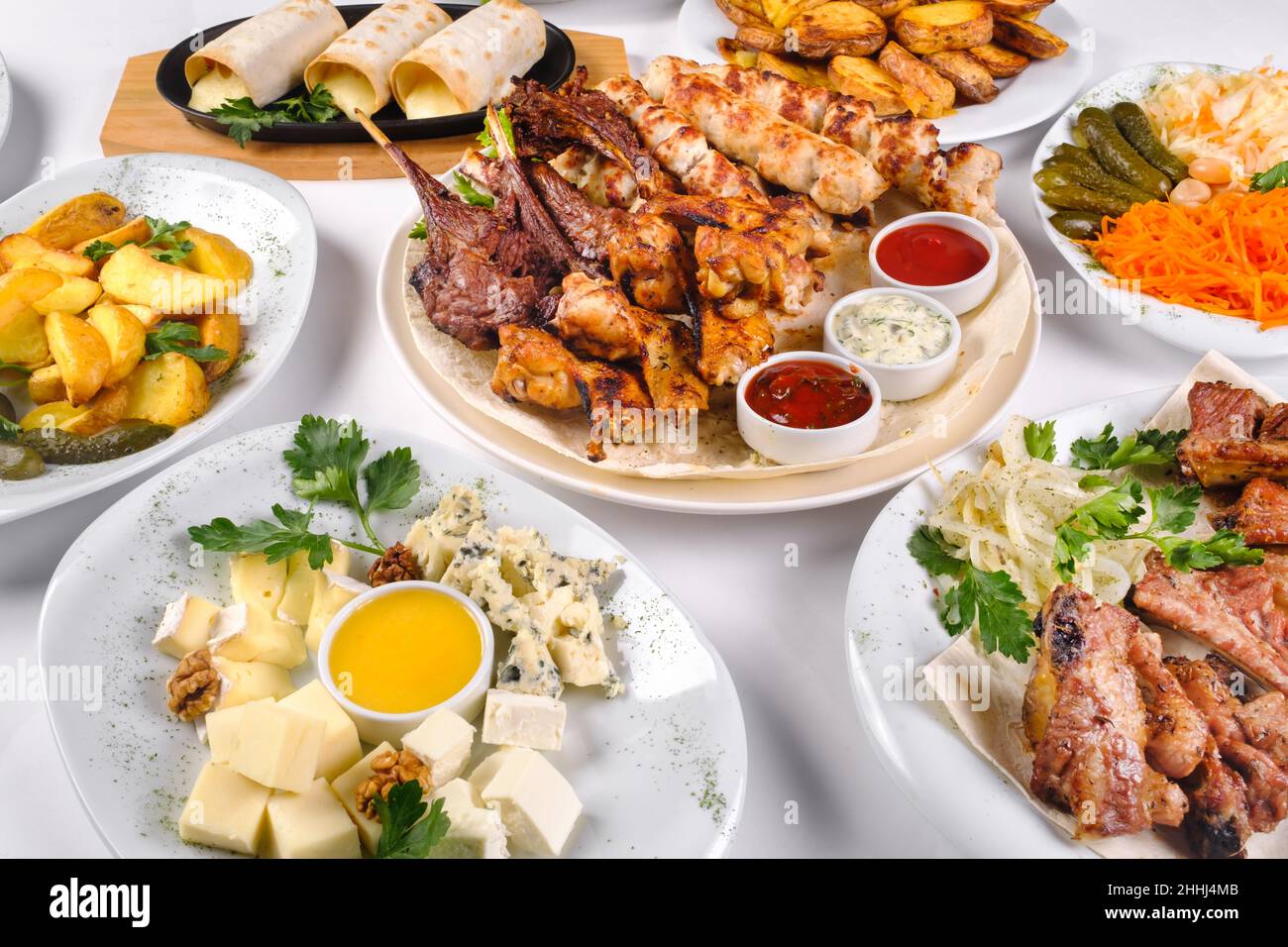 A covered table with many different dinner dishes. Lots of food on a ...