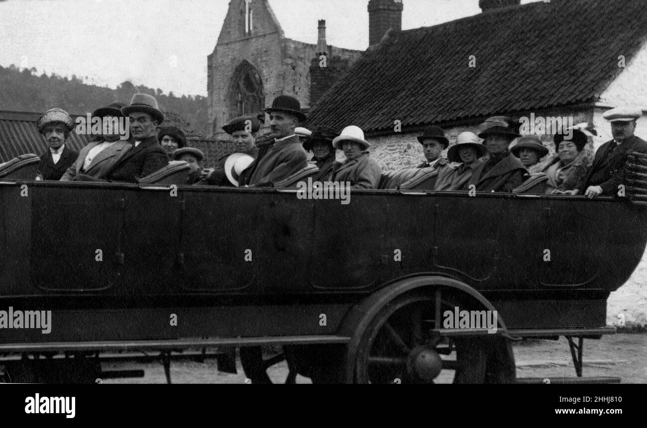 A group of people take their places on the charabanc ready for a day ...