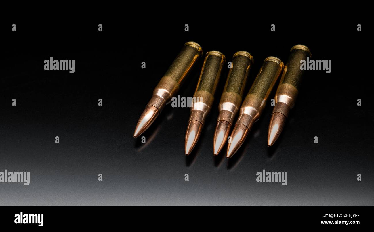 Bullet isolated on black background with reflexion. Rifle bullets close ...