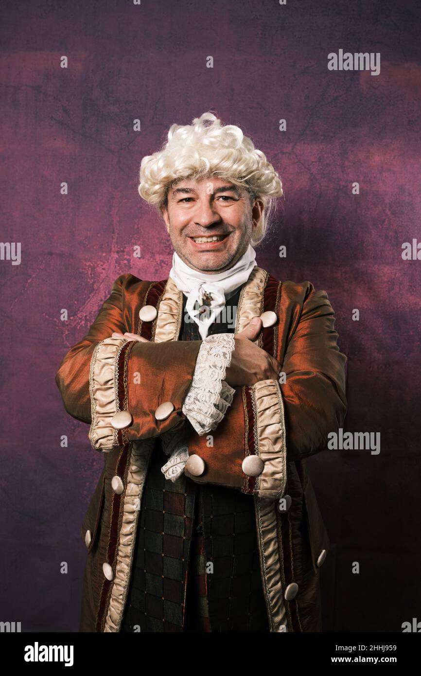 Adult man in classical medieval clothing posing with his arms crossed ...