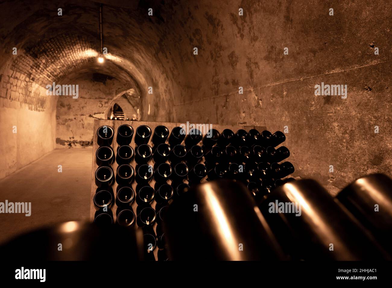 Bottles on racks in deep and long undergrounds caves, making champagne ...