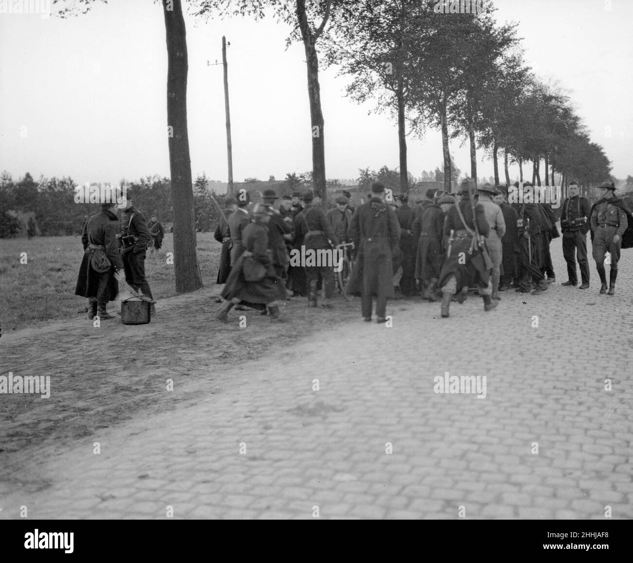 The road to Antwerp. Man wheeling a barrow with the body of his dead ...