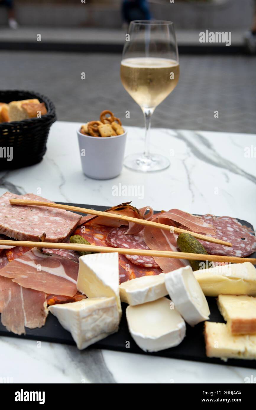 Lunch with glass of brut champagne sparkling wine and meat and cheese ...