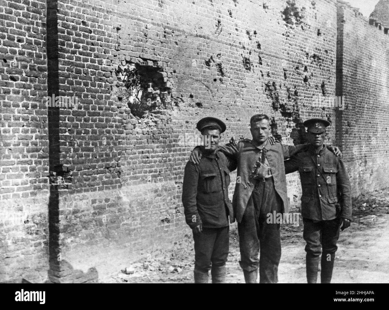 Two soldiers of the Liverpool Scottish regiment stand with a German ...