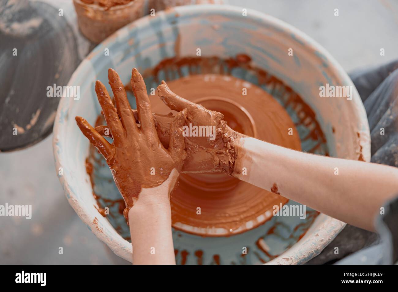 Handmade artist creating earthen bowl on circle in art studio Stock ...