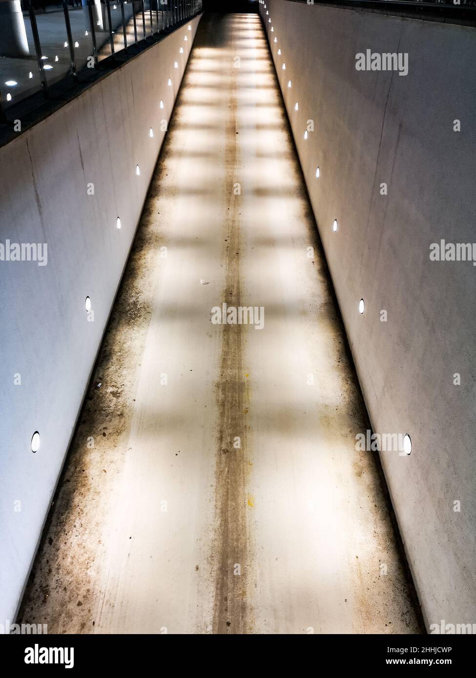 Long entry tunnel full of lights around as entrance to underground ...