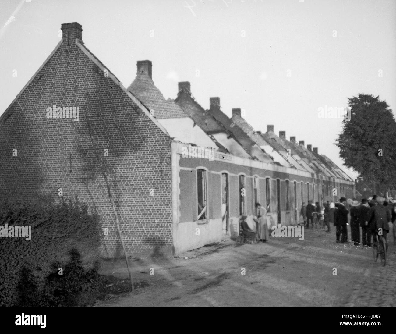 Belgian civilians view the burnt out cottages in Mella . The ...