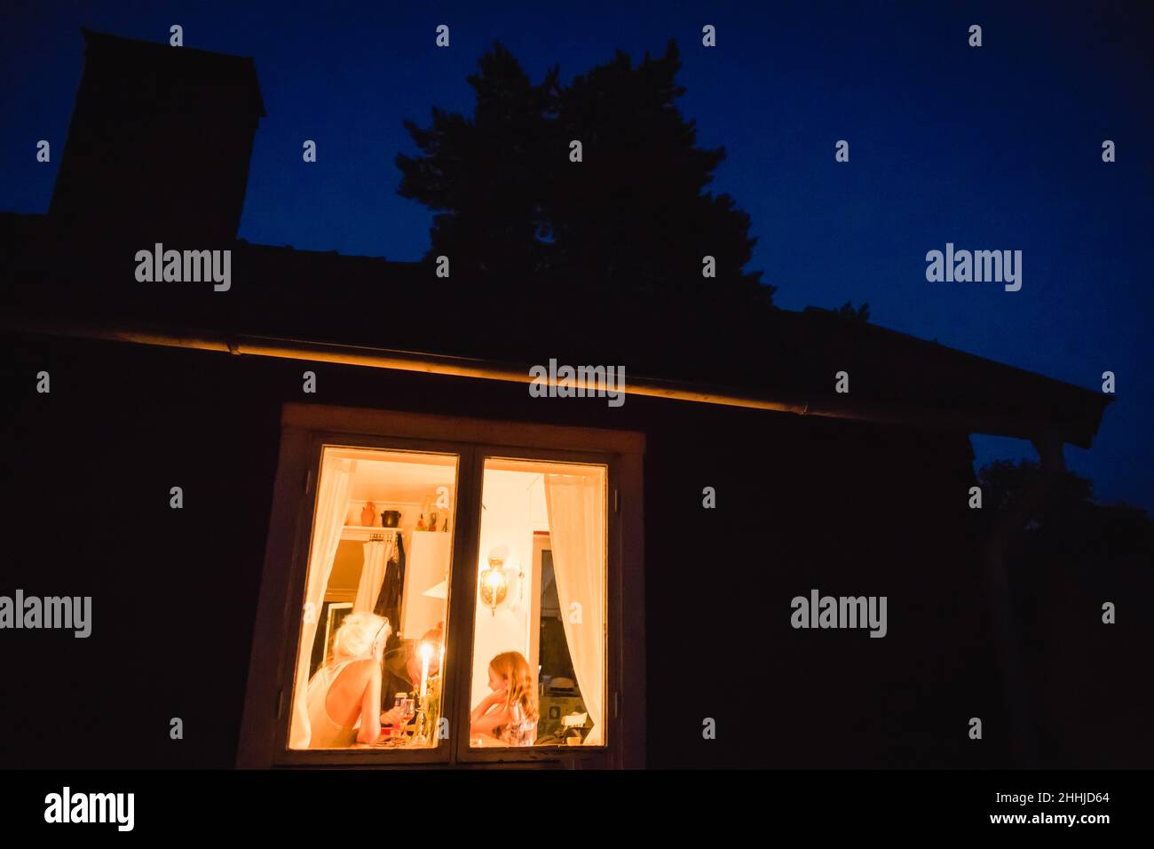 Window in cottage at night Stock Photo - Alamy