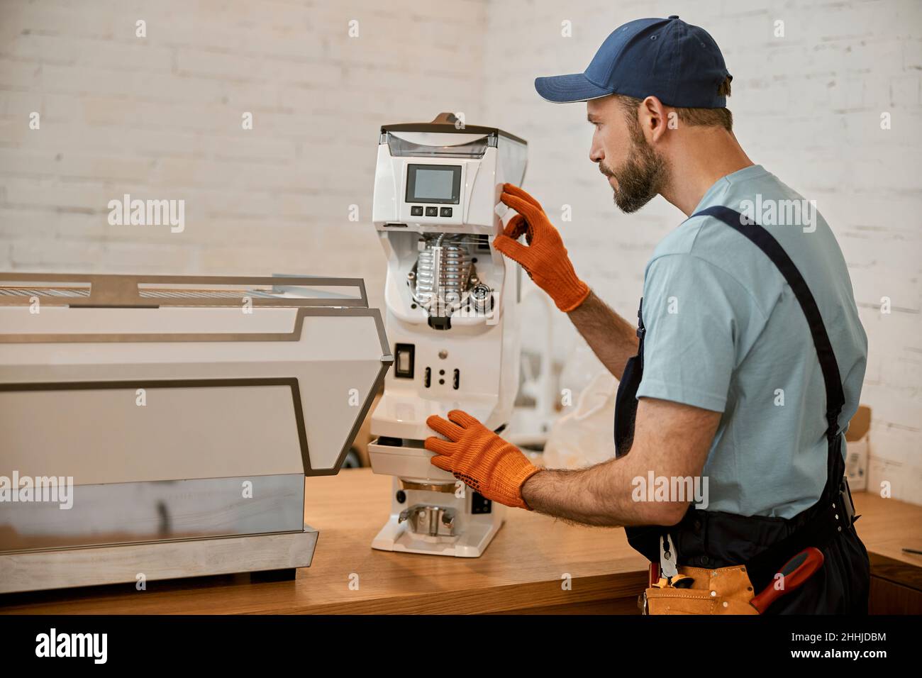 Repairman checking professional coffee maker in cafe Stock Photo - Alamy