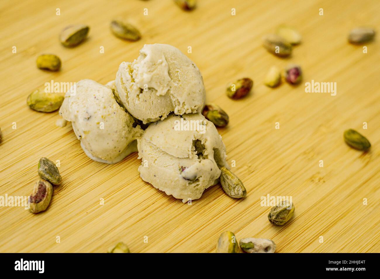 pistachio icecream scoop wood table Stock Photo - Alamy