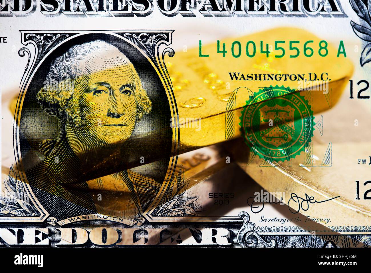 Close-up of an US dollar banknotes and gold-silver ingots Stock Photo ...