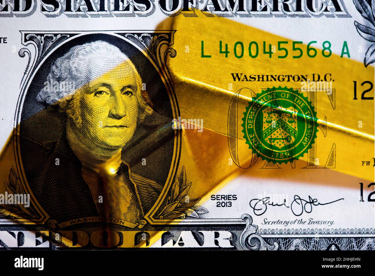 Close-up of an US dollar banknote and gold-ingots Stock Photo - Alamy