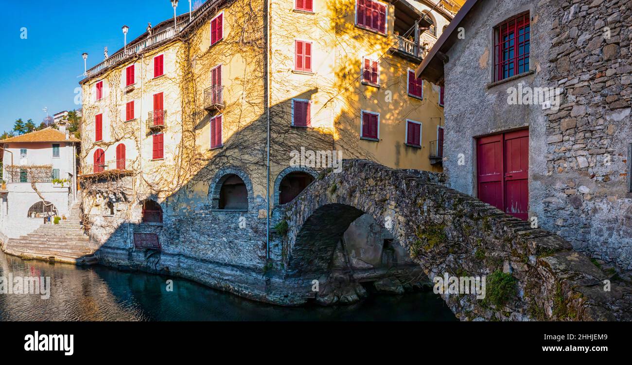 View of the famous stone bridge in Nesso Stock Photo - Alamy
