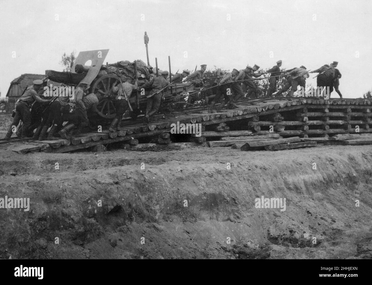 Sappers and gunners pull a artillery piece up the slope over the ...