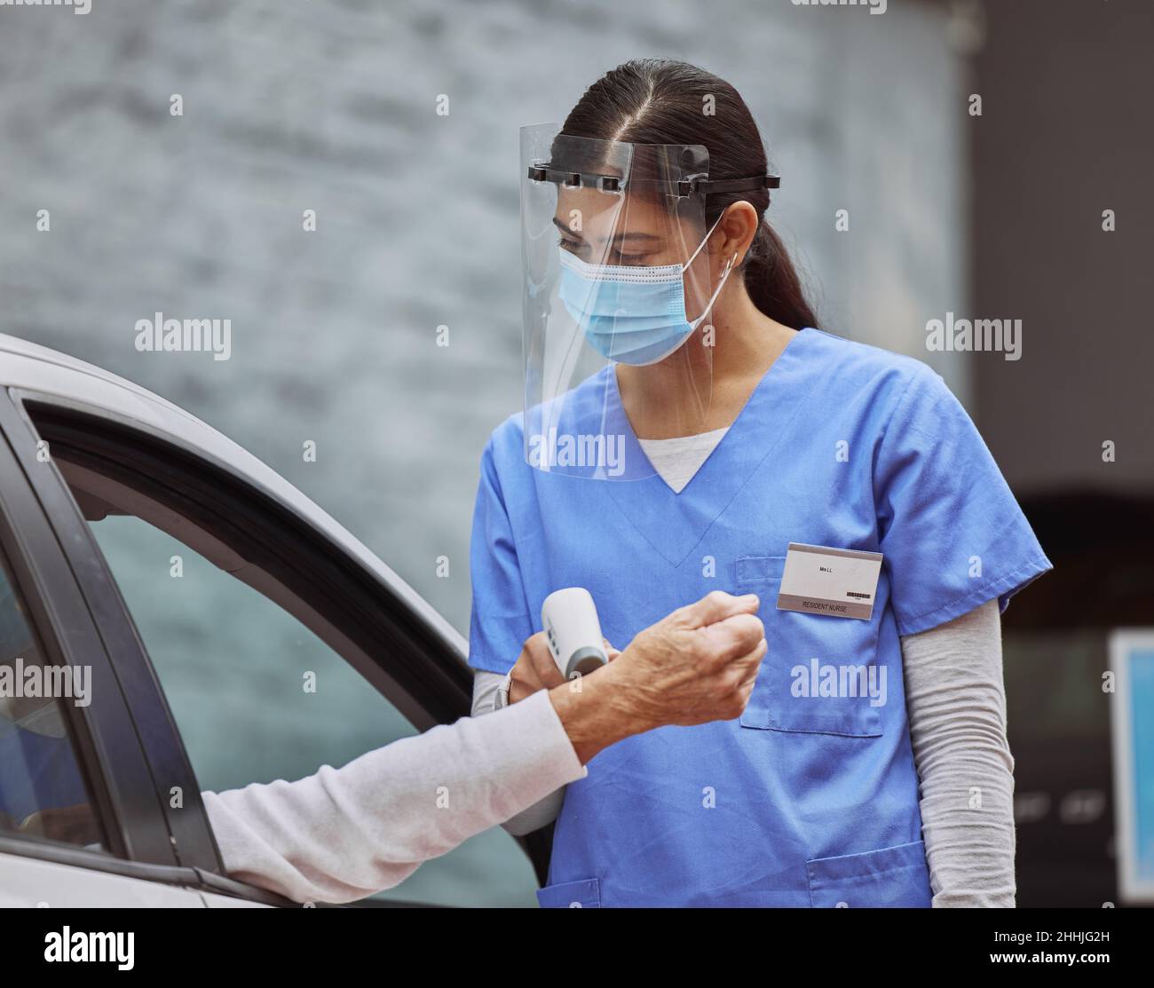 Your temperature seems normal. Shot of a young healthcare worker taking ...