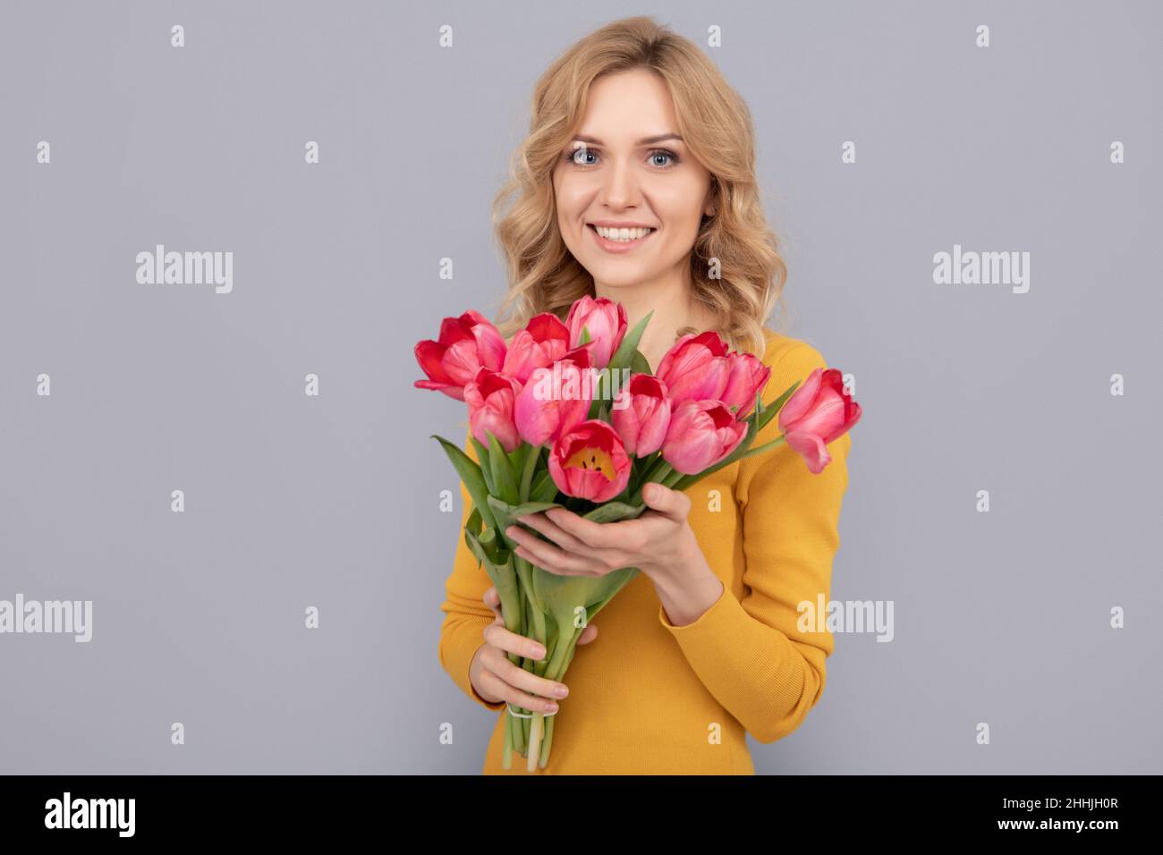 happy woman with tulips. lady hold flowers for spring holiday. glad ...