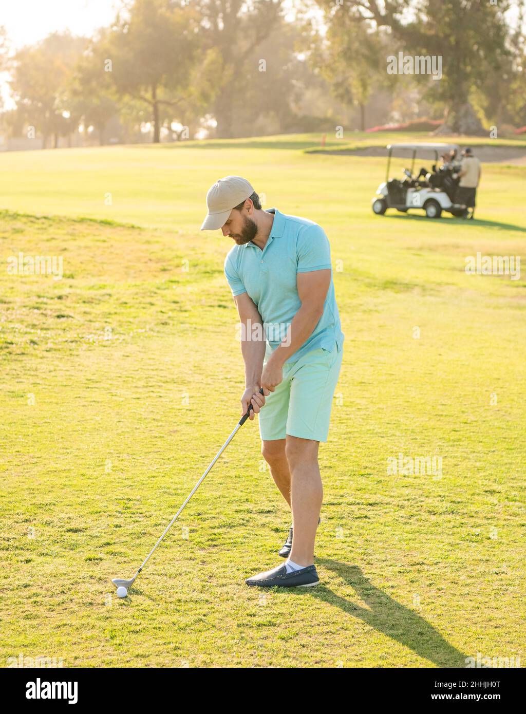 male golf player on professional golf course. golfer in cap with golf ...