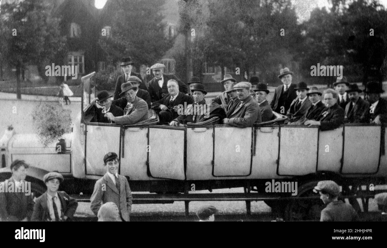 A group of people take their places on the charabanc ready for a day ...