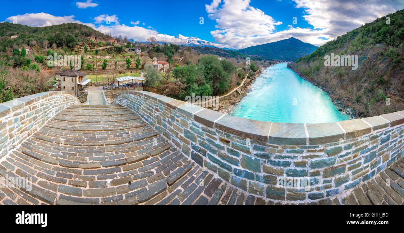 The great arched stone bridge of Plaka on Arachthos river, Tzoumerka ...