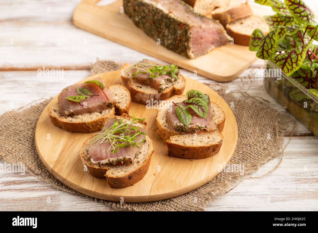 Bread sandwiches with jerky salted meat, sorrel and cilantro microgreen ...