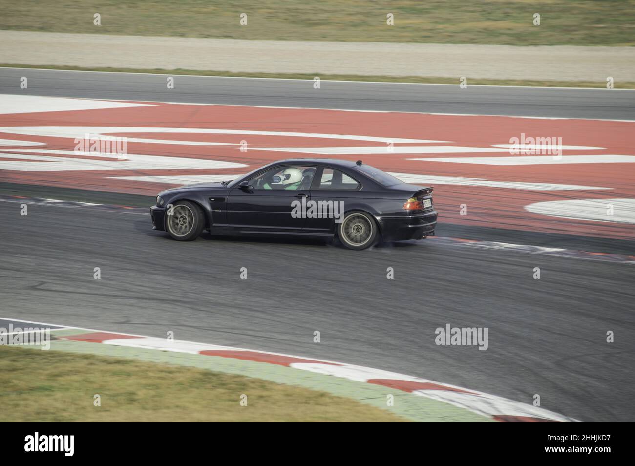 Black BMW E46 drifting on the circuit with motion in the background in ...