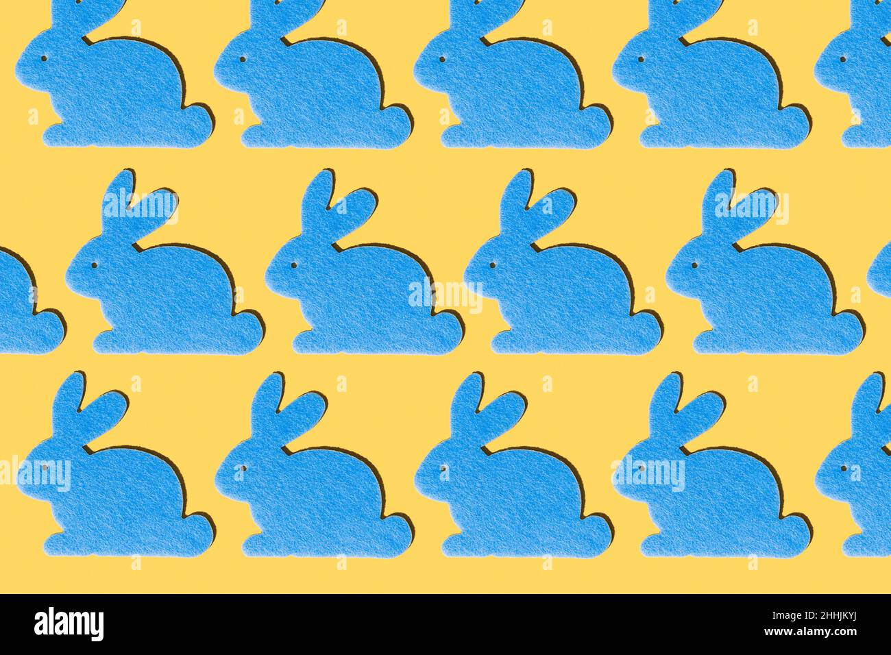 Blue rabbits pattern on a yellow background Stock Photo - Alamy