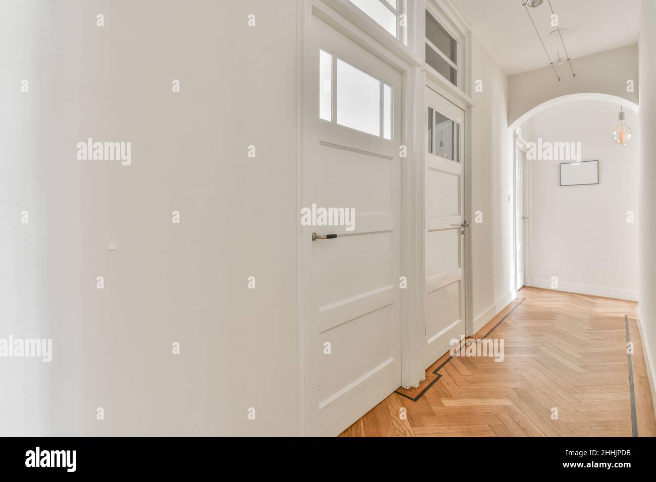 Interior of light corridor with frame on white walls and closed room ...