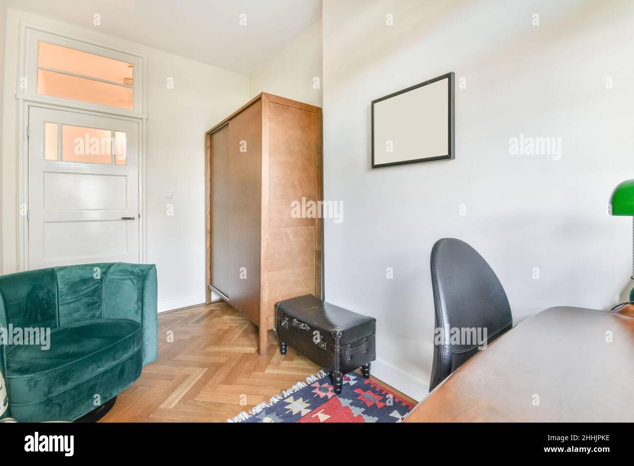 Big wooden closet placed near table with modern computer in light home ...