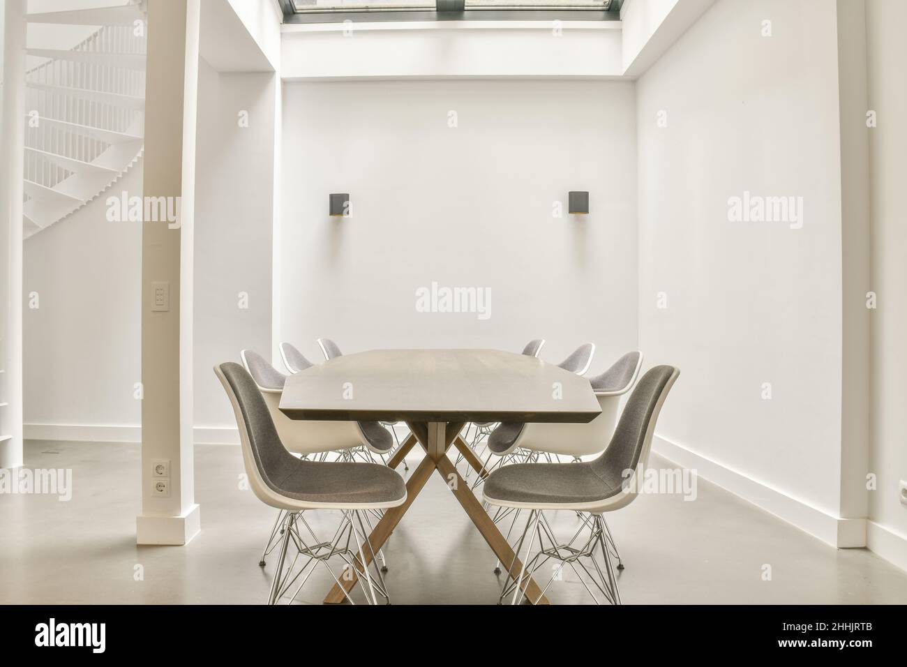 Interior of meeting room with wooden table and chairs placed near white ...