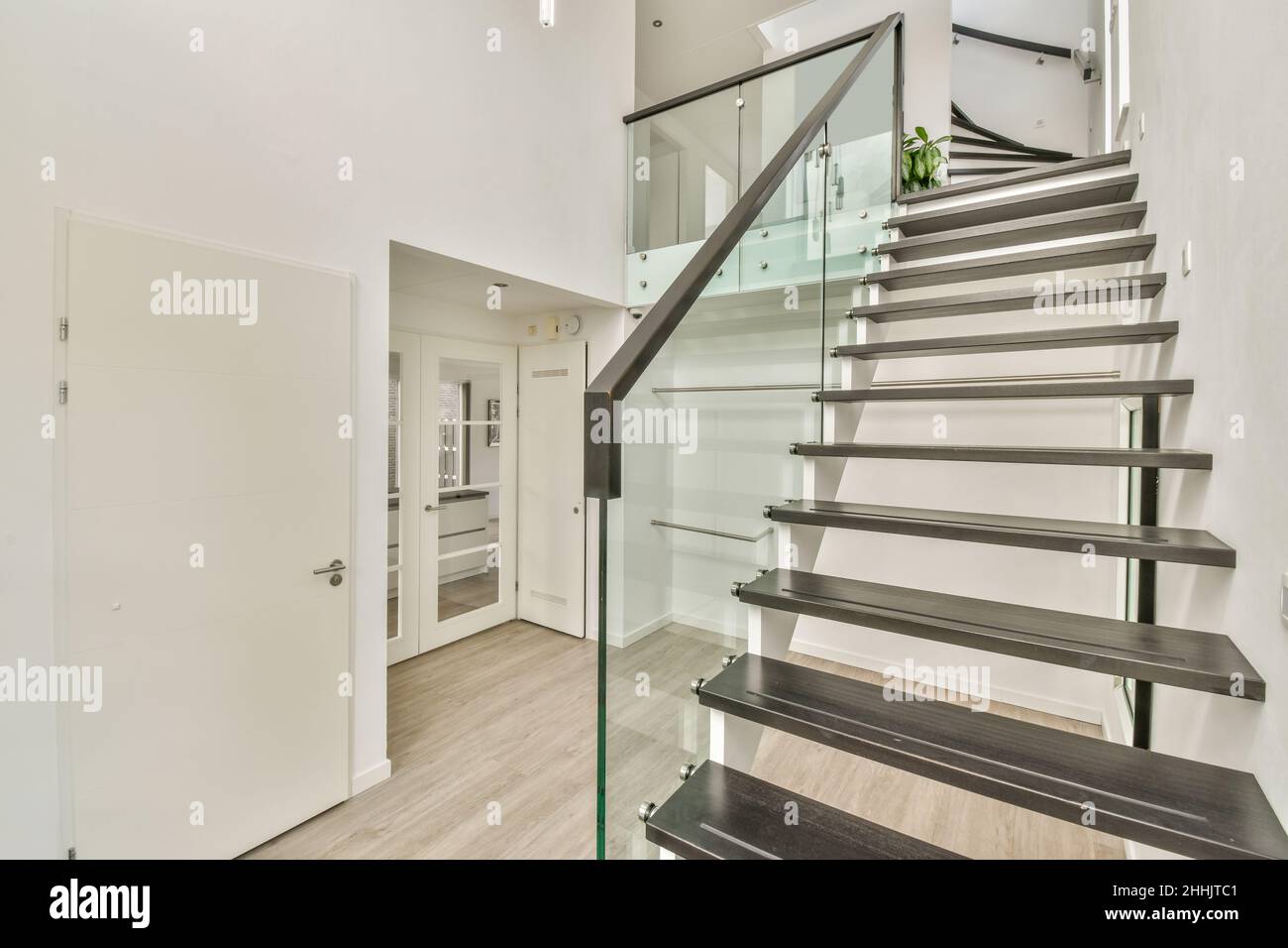 Interior of hallway at entrance of modern big home with stairway ...