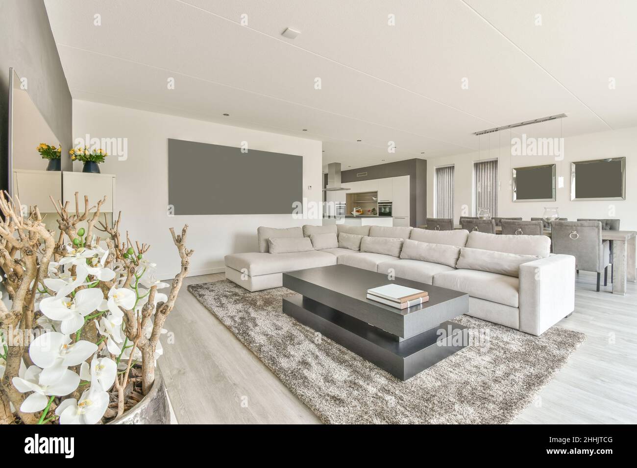 Comfortable chairs around wooden dining table in big house with living ...