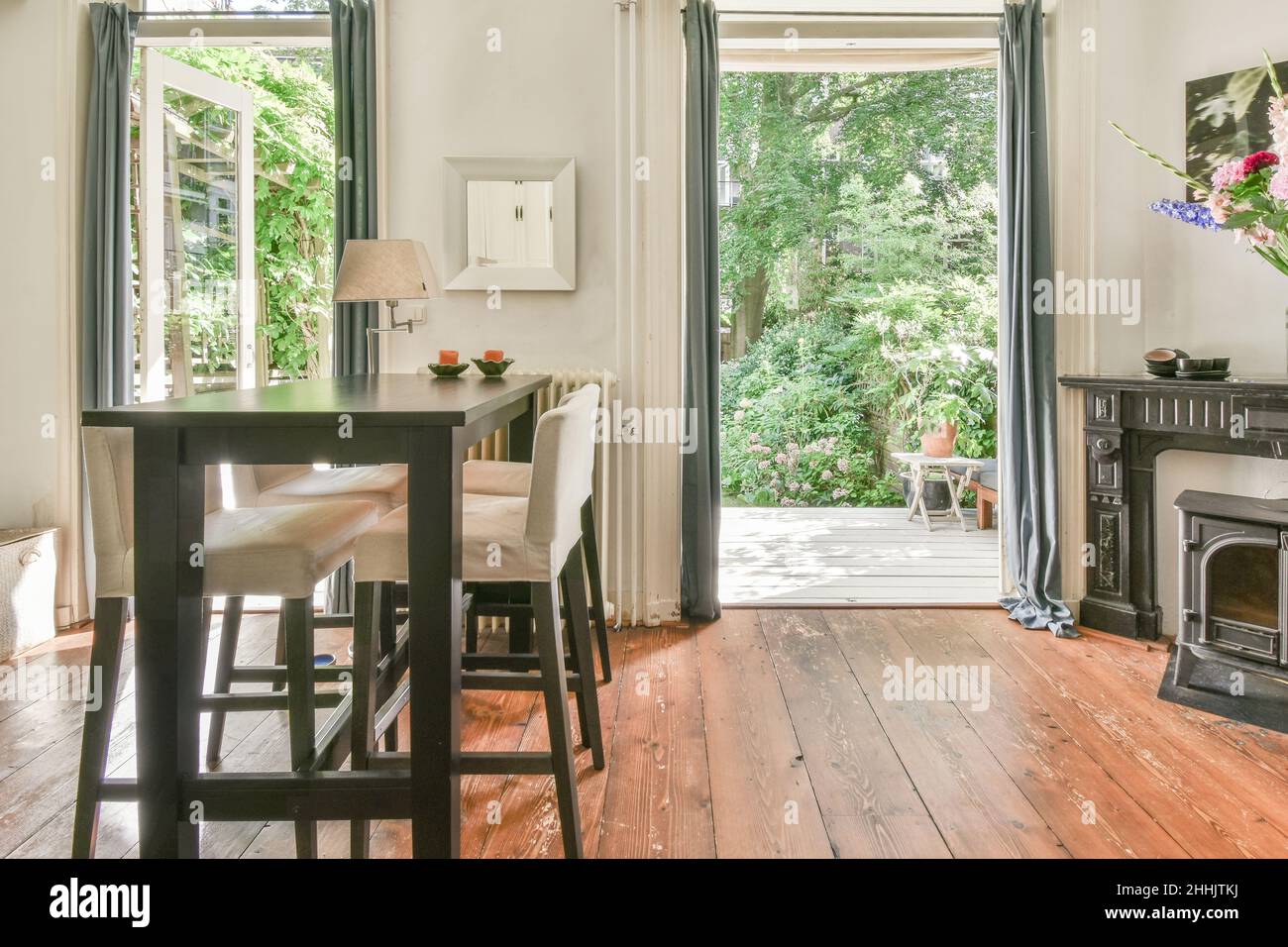 Interior of light dining room with wooden table surrounded with chairs ...
