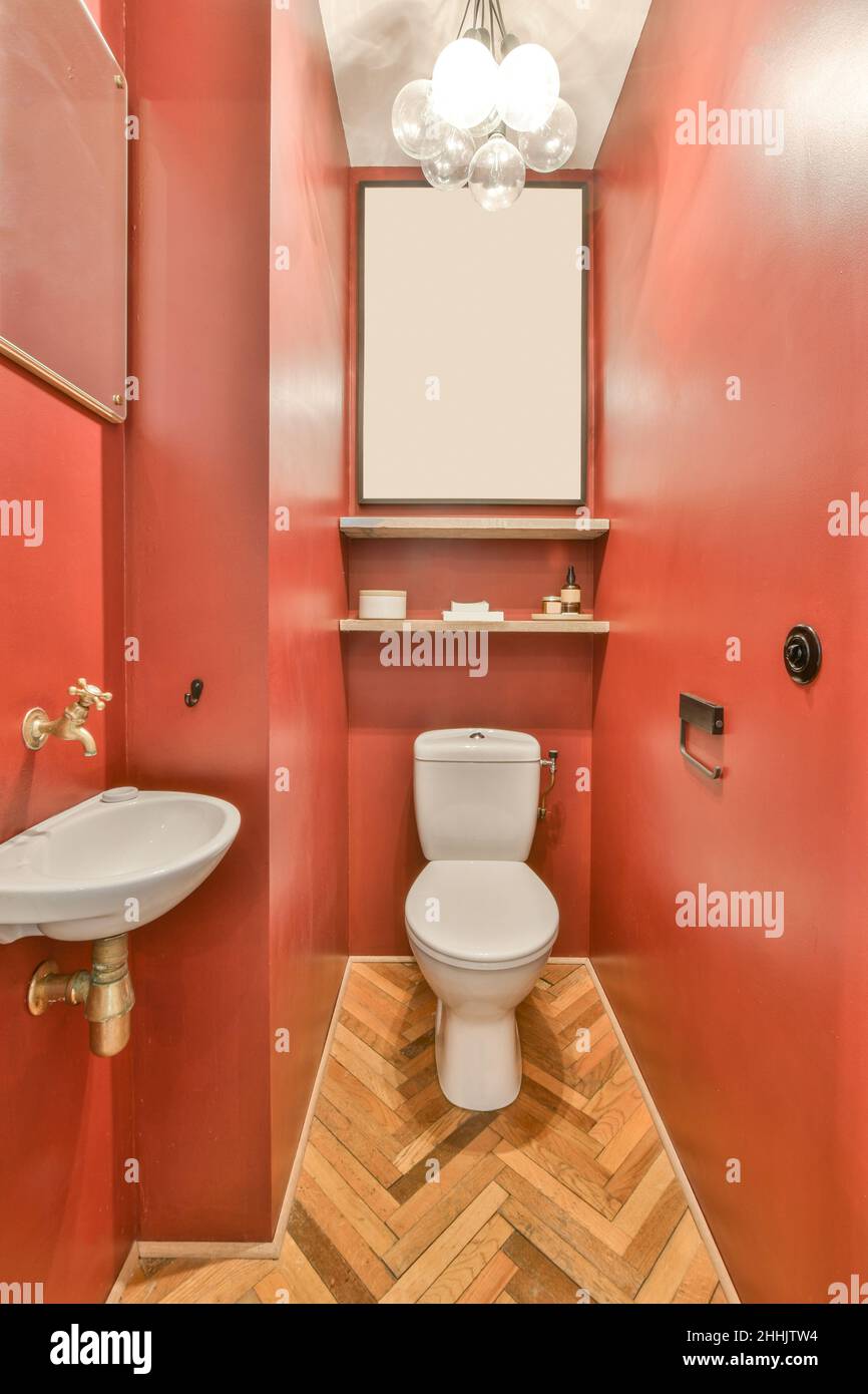 Interior of modern restroom with red walls parqueted floor and white ...