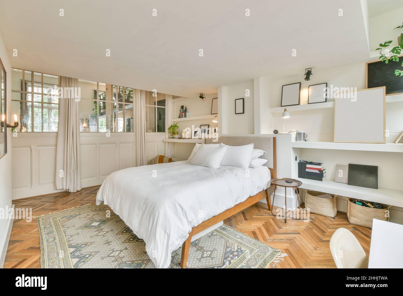 Interior of modern stylish bedroom with comfortable bed covered with ...