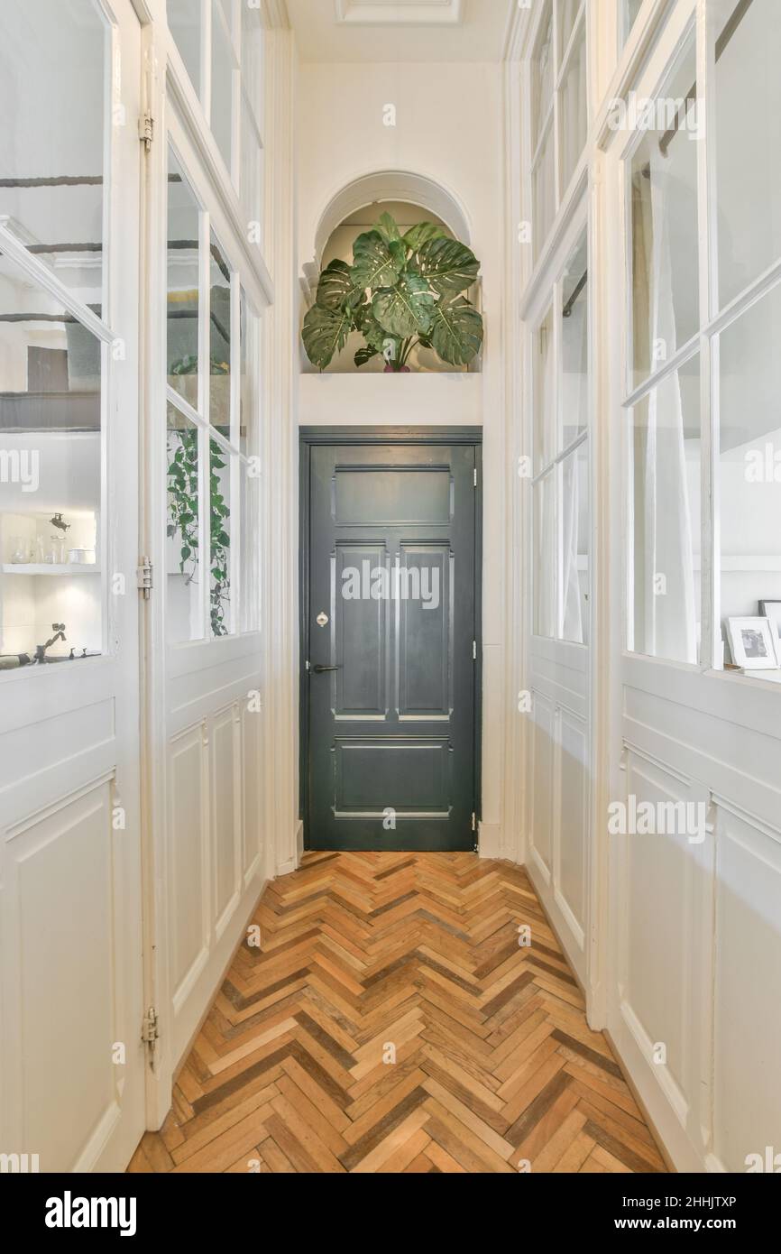 Interior of light narrow corridor with white glass walls and wooden ...