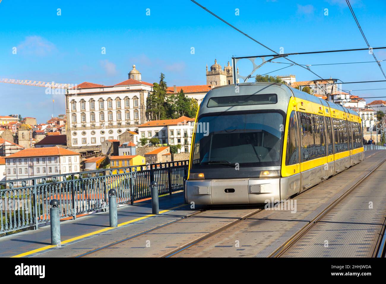 Modern metro train on the bridge in Porto in a beautiful summer day ...