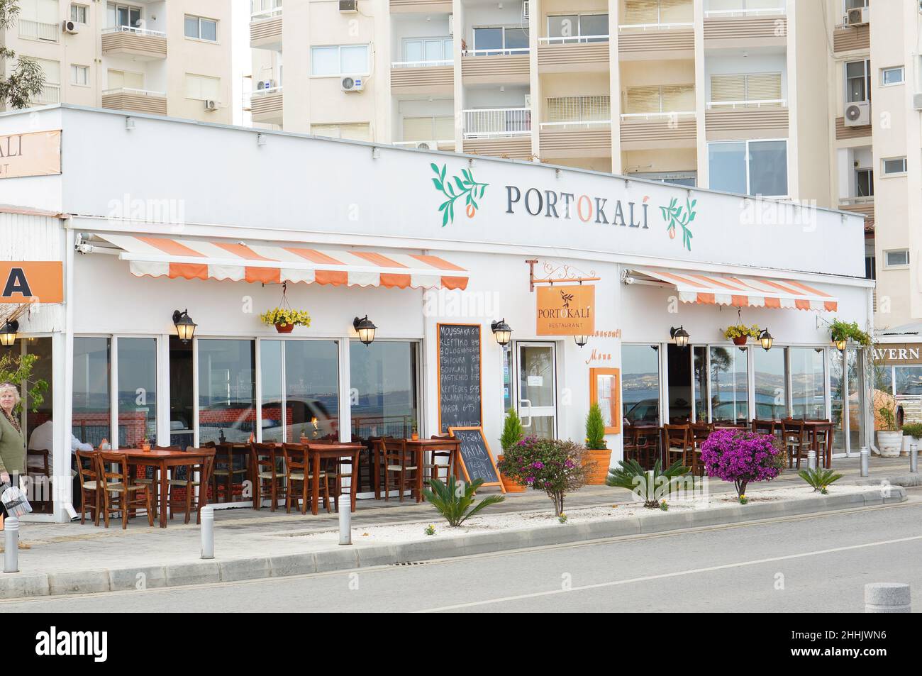 Exterior of a fish restaurant with tables and chairs standing outside ...