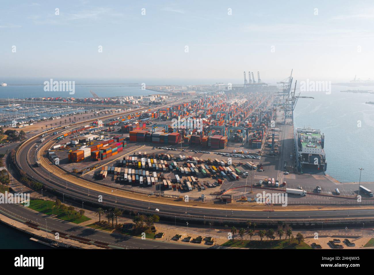 Drone view of Valencia port with cargo containers and cars near ship ...