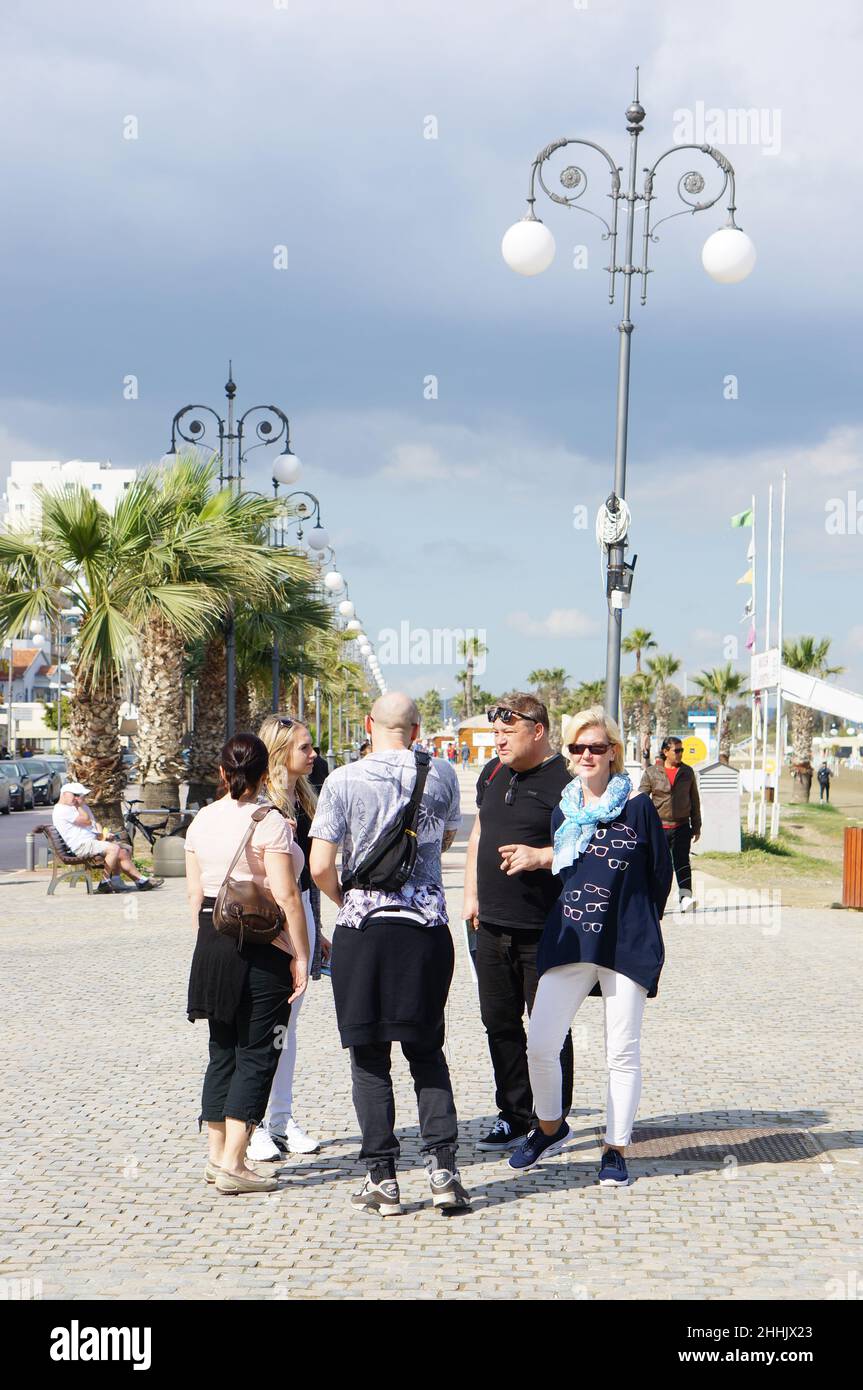 Group of people gathering on a square with high lamps Stock Photo - Alamy