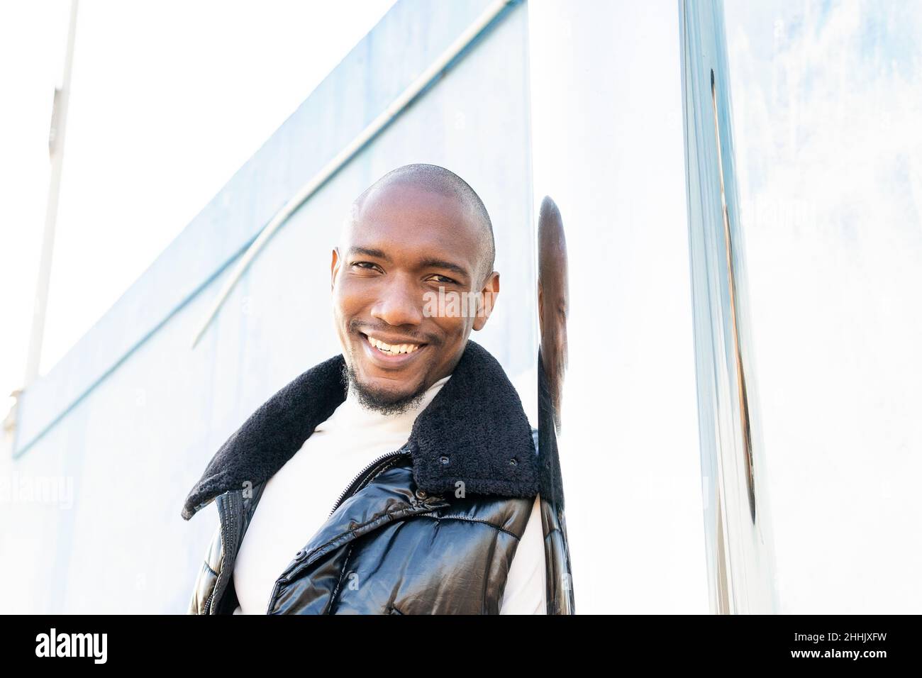 Side view faceless male leaning on wall while standing in creative ...
