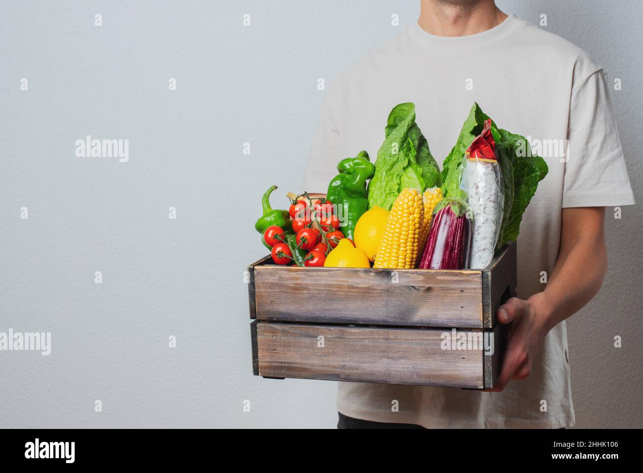 Delivery Concept -Young Caucasian delivery man carrying wooden box of ...